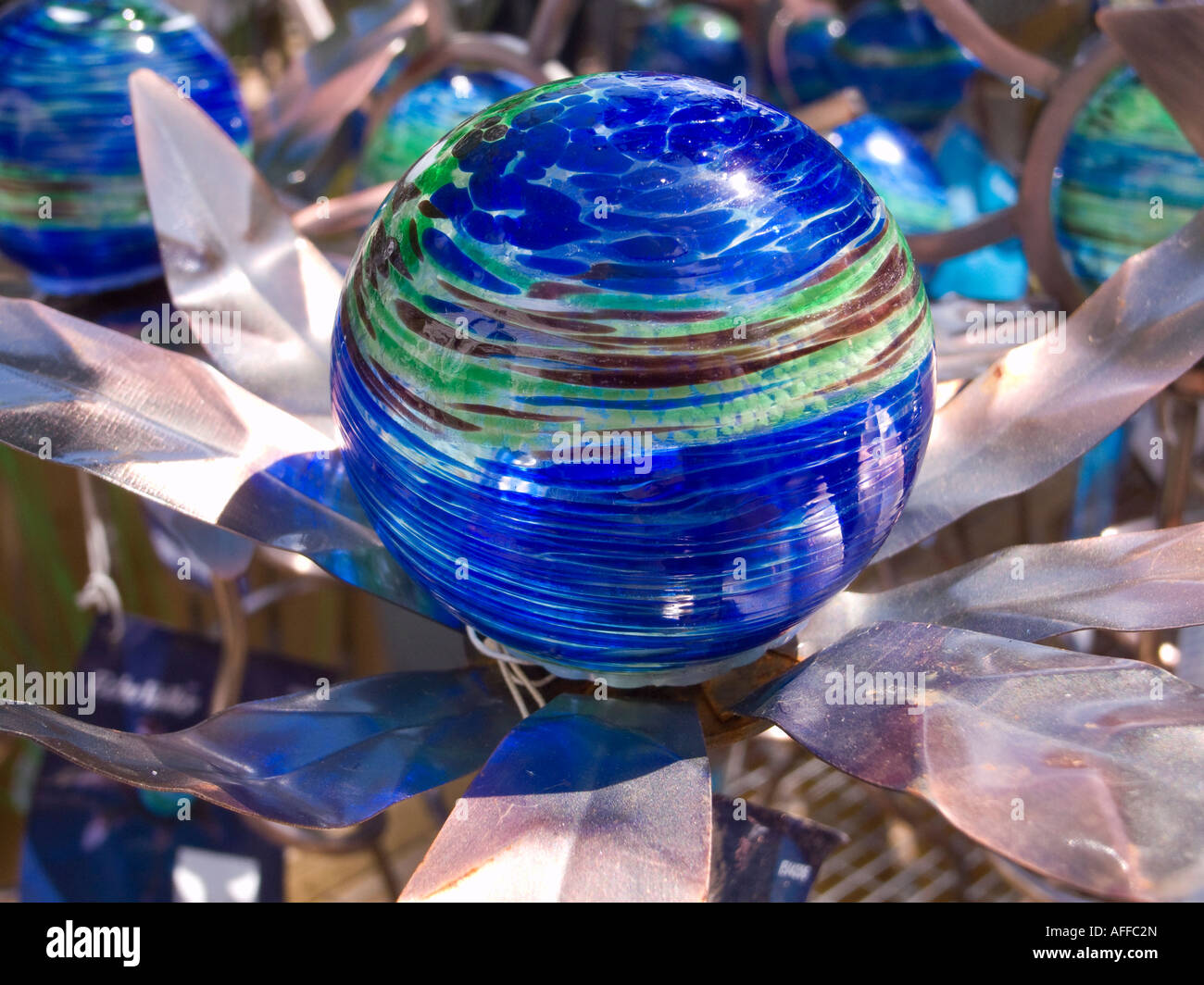 Decorative garden ornament in the shape of a metal flower with a blue ...