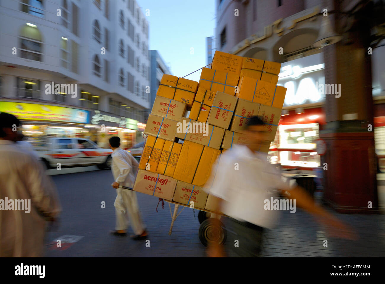 man dragging a fully loaded cart, Dubai City, United Arab Emirates ...