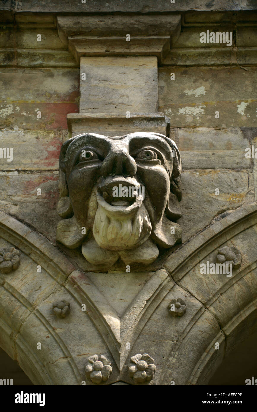 Laughing carved stone gargoyle on garden wall - UK Stock Photo - Alamy