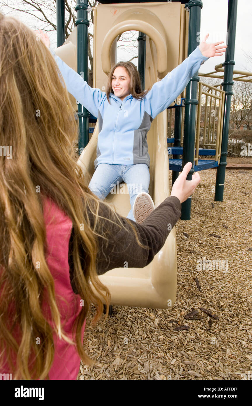 2 Teenage Girls On Slide Stock Photo - Alamy