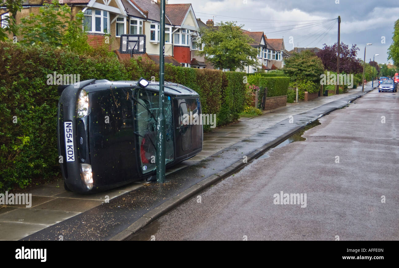 Overturned car on pavement London England Stock Photo - Alamy