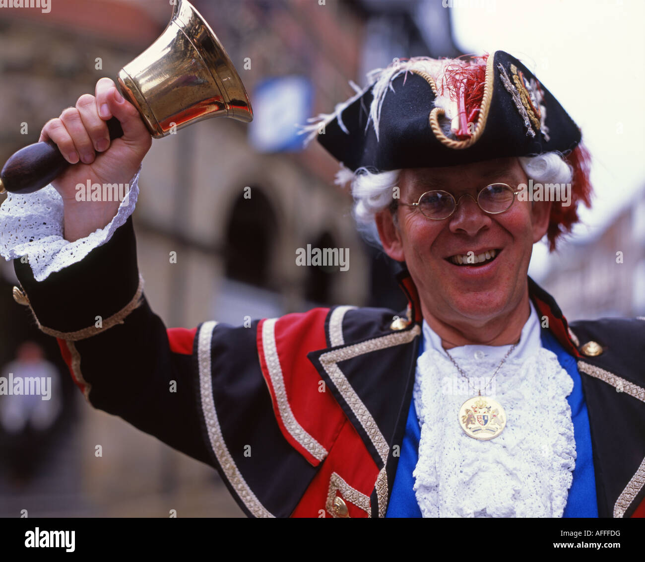 Town Crier, in full costume and tricorne hat, rings his bell in Chester ...