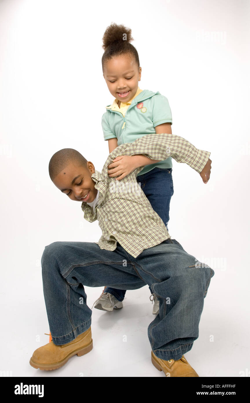 Little Sister Helps Brother Stock Photo - Alamy