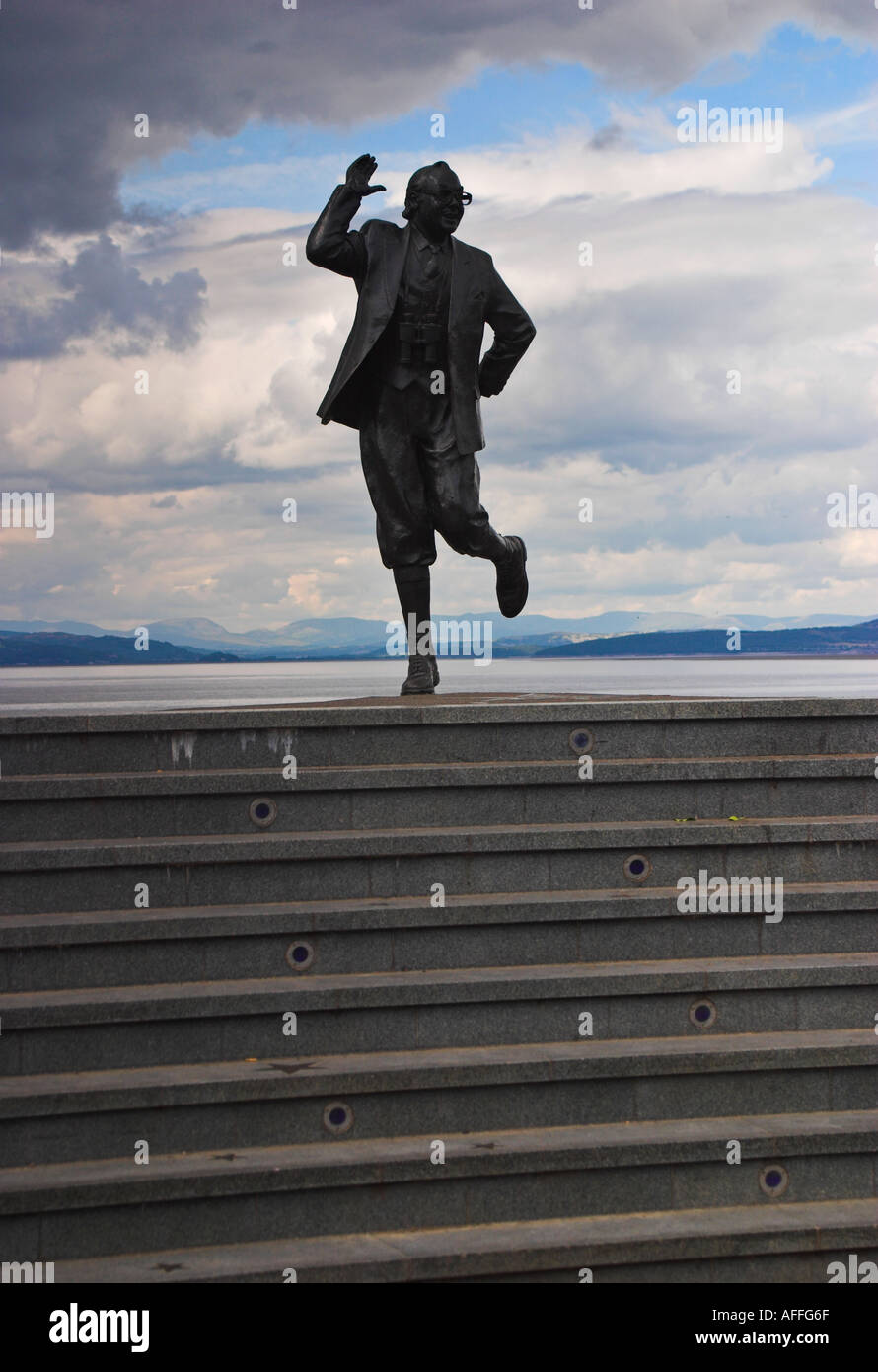 Silhouette of Eric Morecambe statue (of Morecambe and Wise) on the sea ...