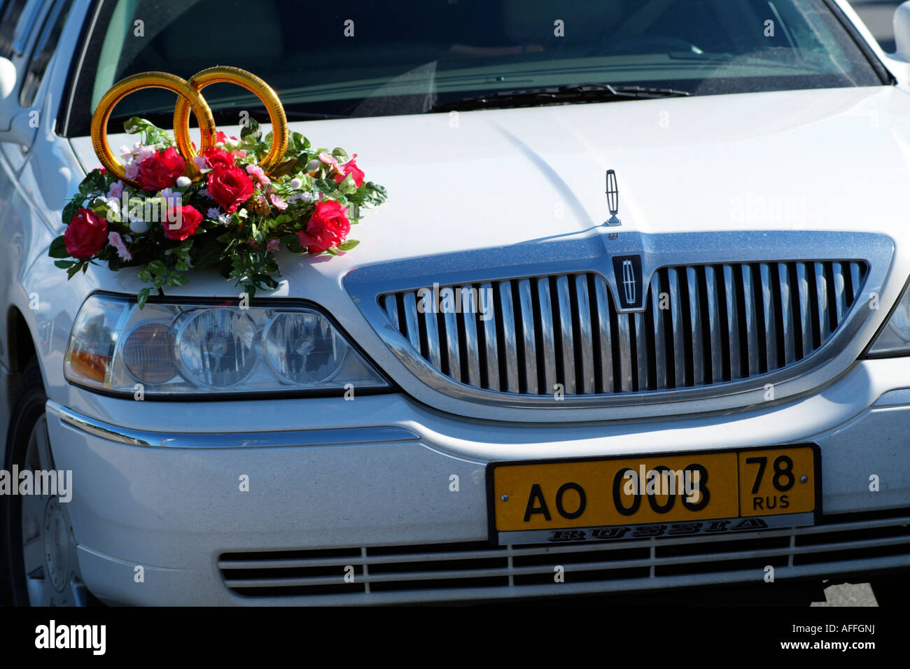 White Wedding Car with Flower Bouquet and Gold Rings displayed on the ...