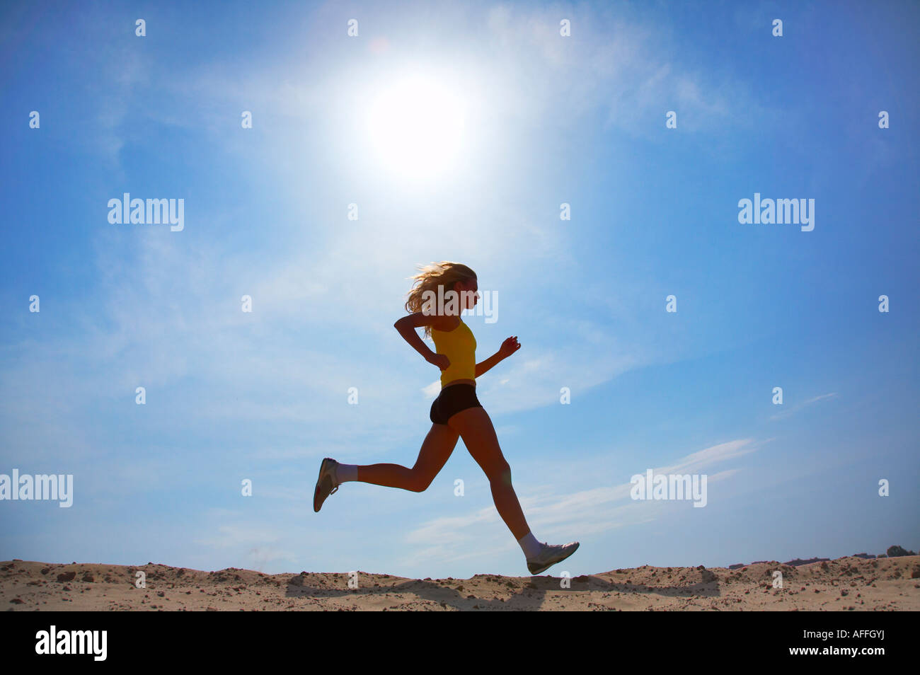 Running woman with sky Stock Photo - Alamy