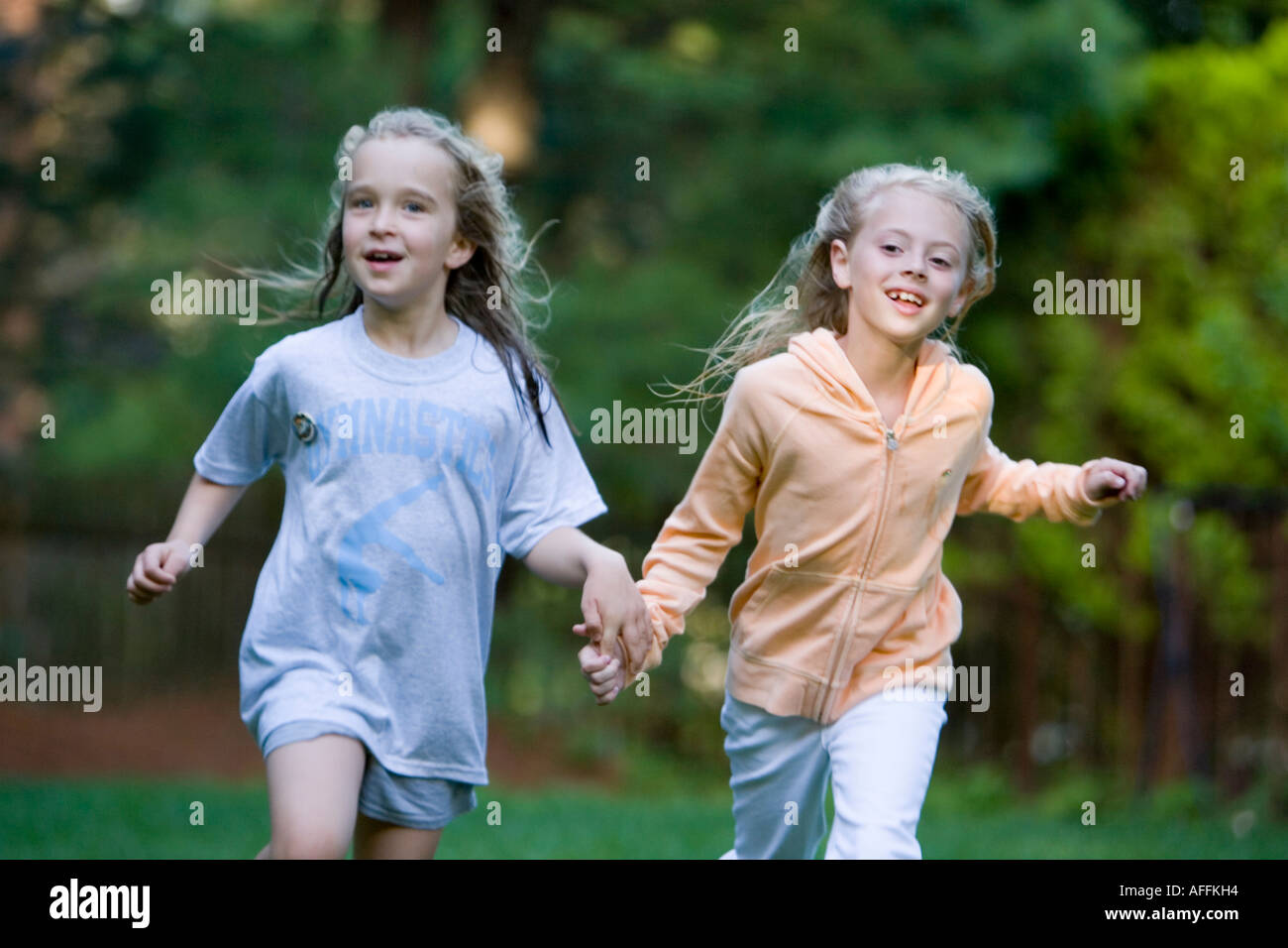 Two friends running together Stock Photo - Alamy