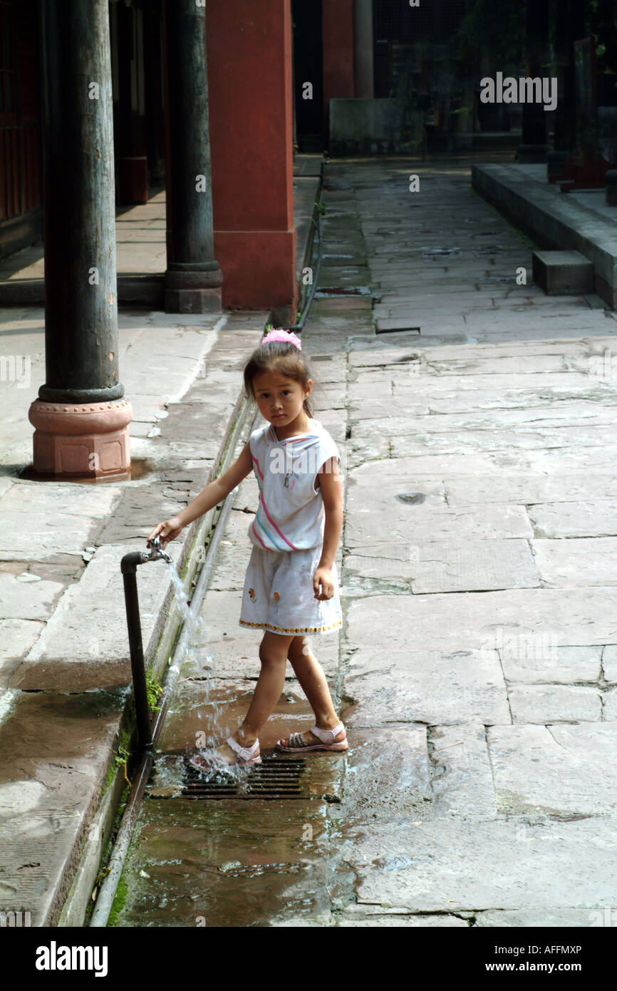 A little girl washes her feet at a Buddhist monastery in Chengdu ...