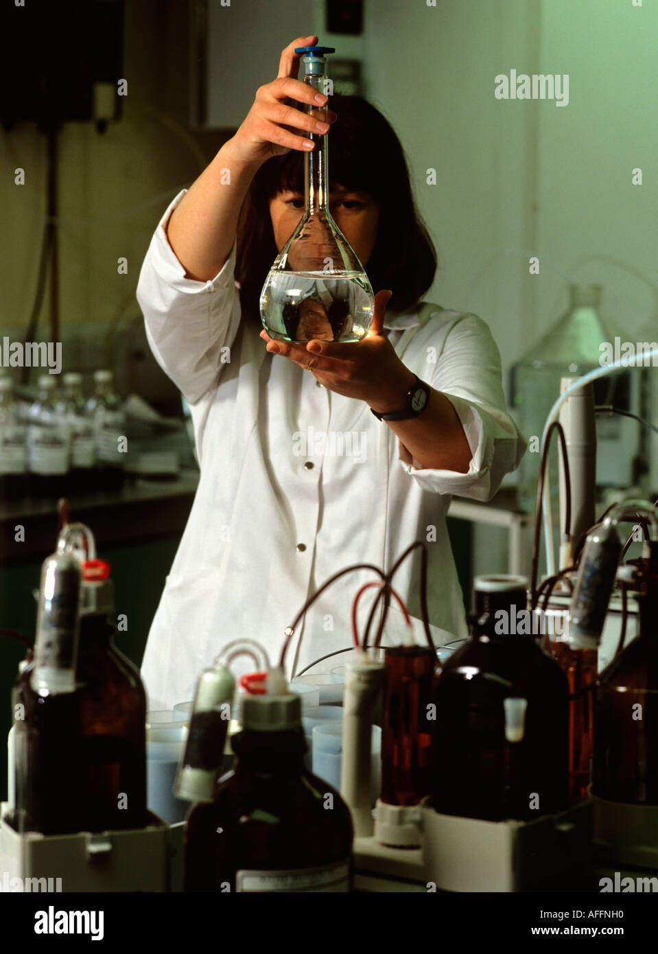Science female Environment Authority scientist analysing a water sample ...