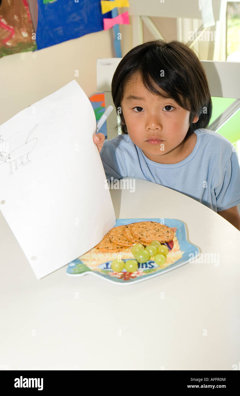 Sad Young Boy Holding up Homework Stock Photo - Alamy