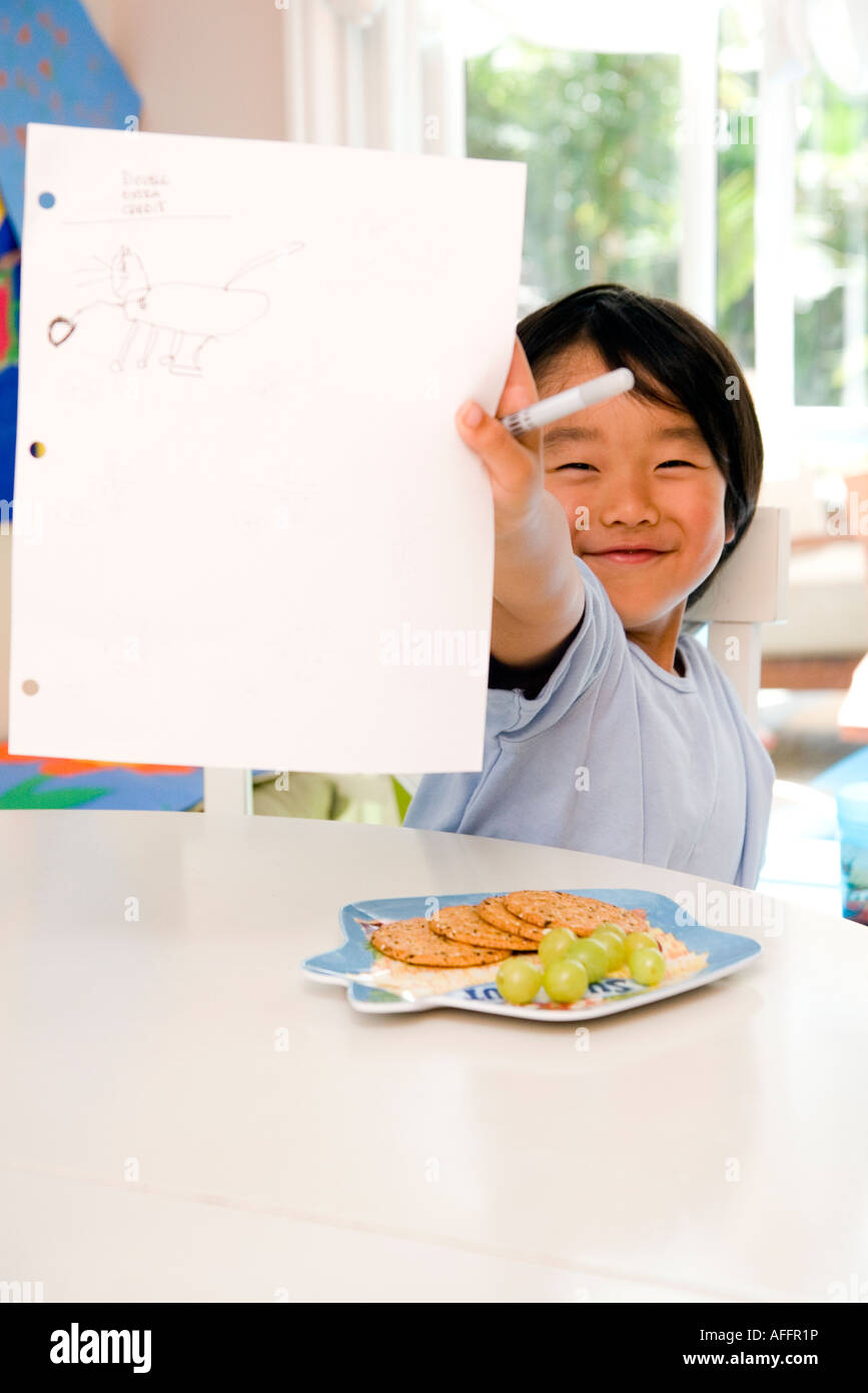Young Boy Holding up Homework Stock Photo - Alamy