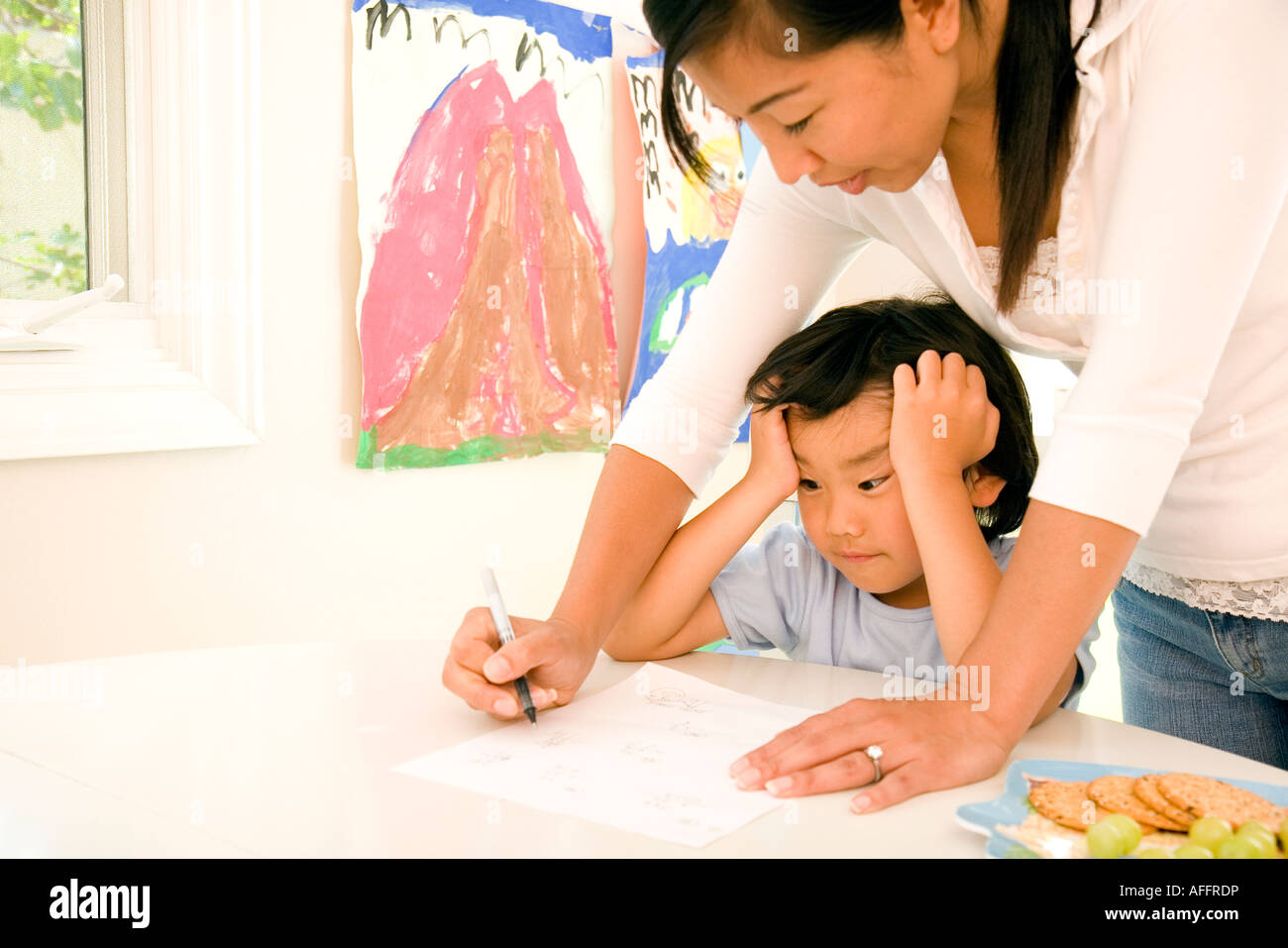 Mom Helping Son with his Homework Stock Photo - Alamy