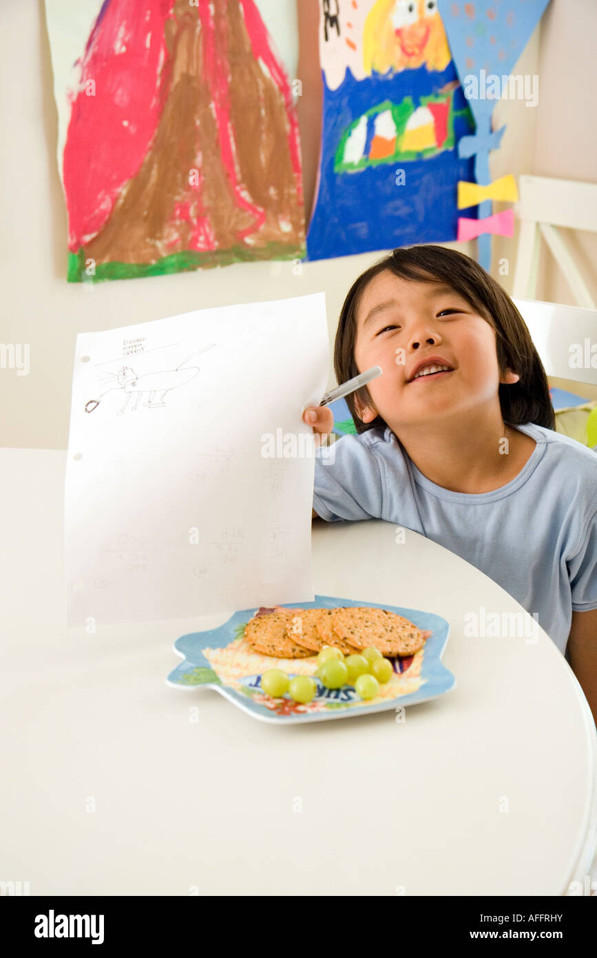 Young Boy Holding up Homework Stock Photo - Alamy