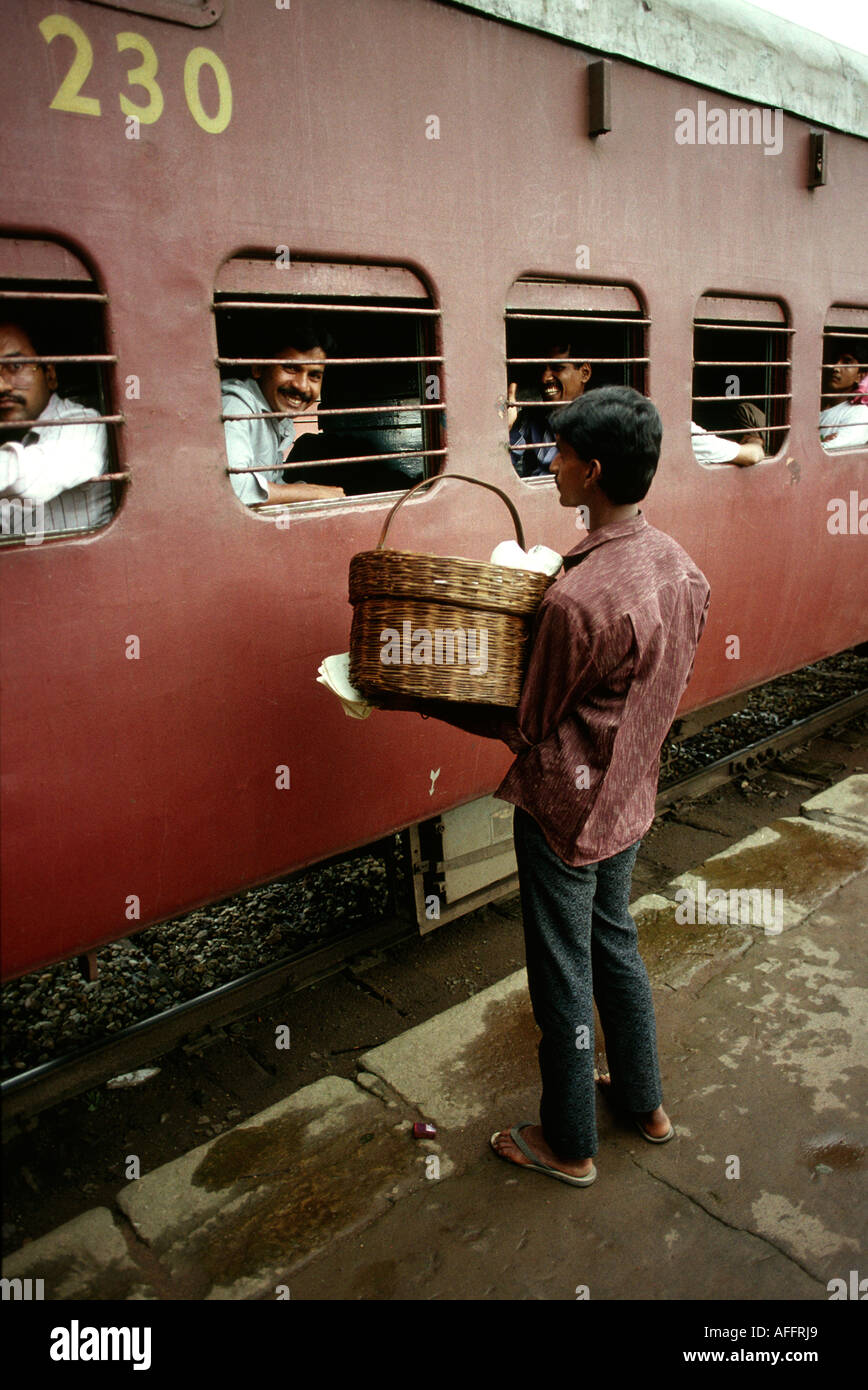 India Karnataka rail travel transport food snack vendor at train window ...