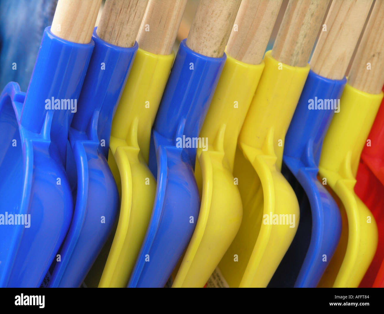 Childrens plastic brightly coloured sea side spades Stock Photo - Alamy
