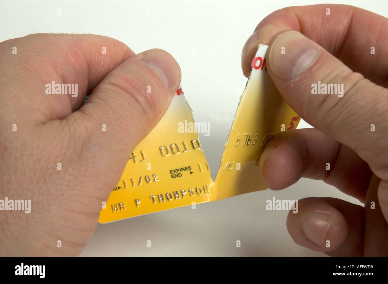 Man tearing credit card in two Stock Photo - Alamy