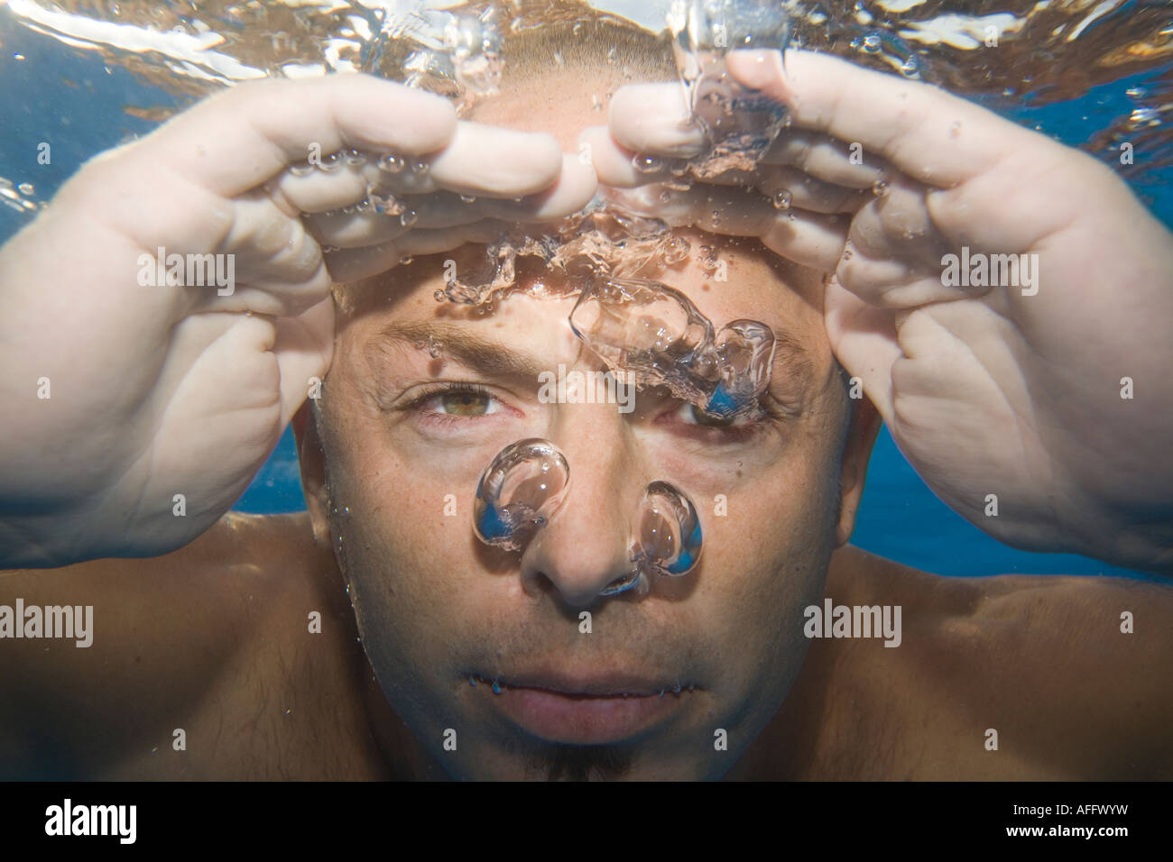 Man under water looking for something Stock Photo - Alamy