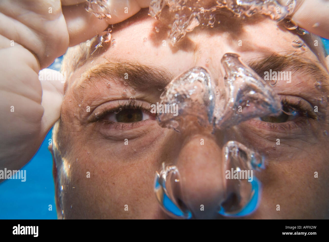 Man under water looking for something Stock Photo - Alamy