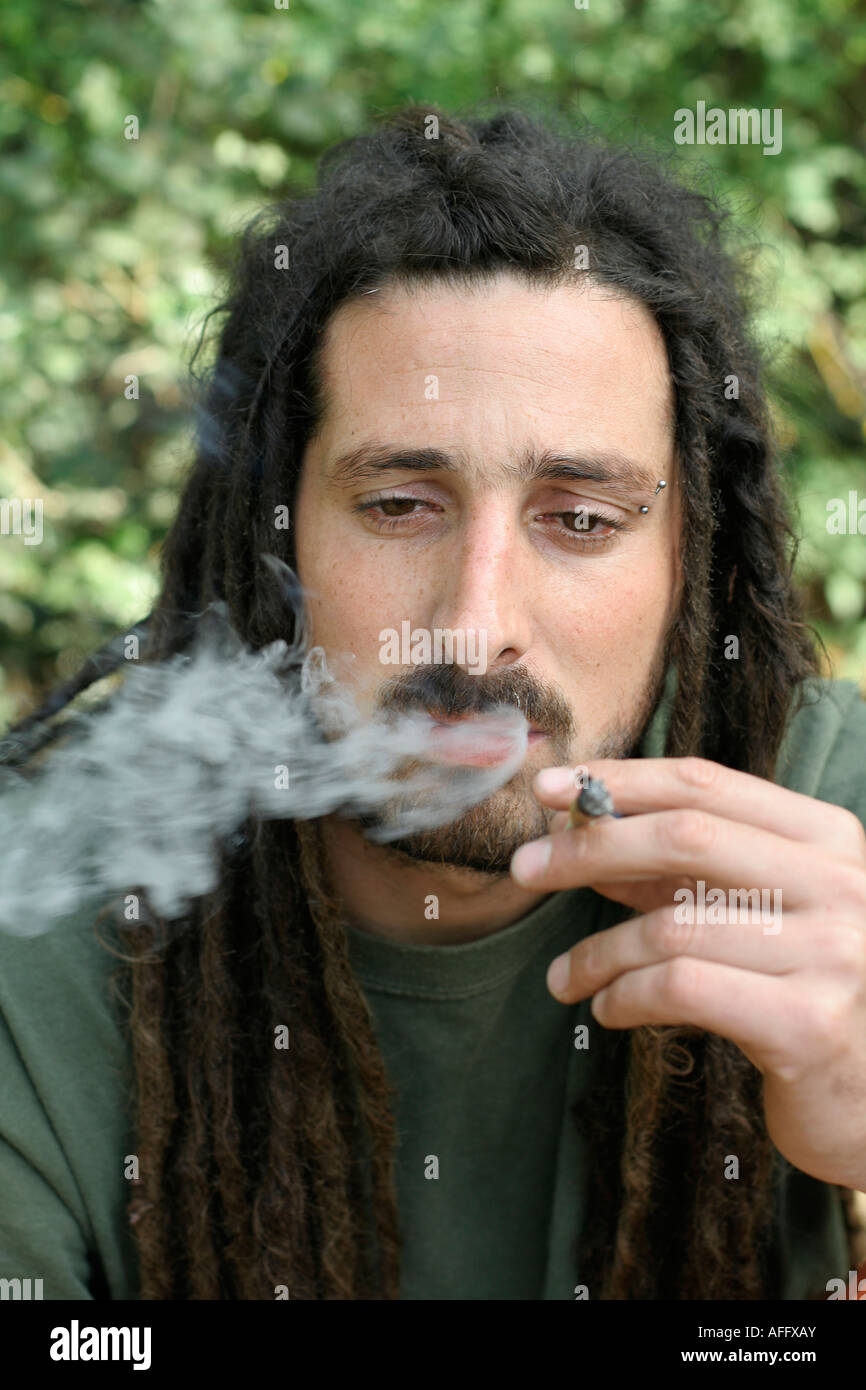 hippy preparing rolling and smoking marijuana joint photos series Stock Photo - Alamy