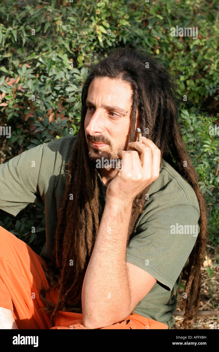 hippy preparing rolling and smoking marijuana joint photos series Stock ...
