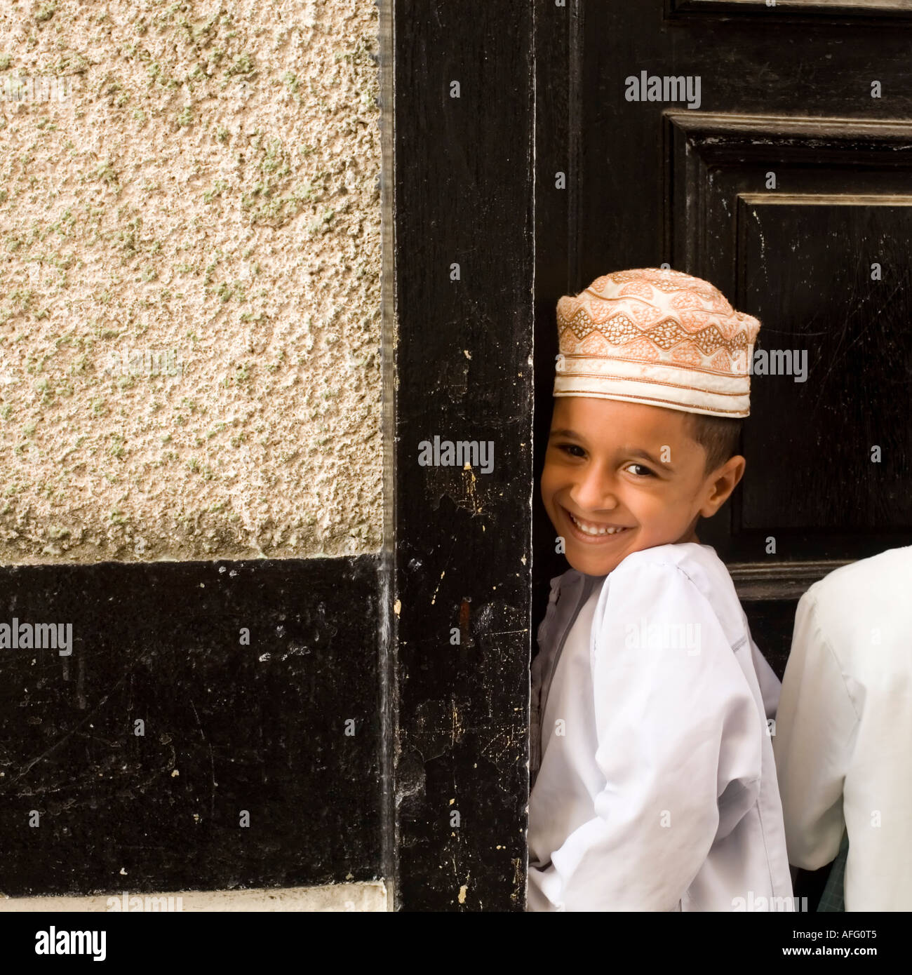 Child hiding in doorway Stone Town, Zanzibar Stock Photo - Alamy