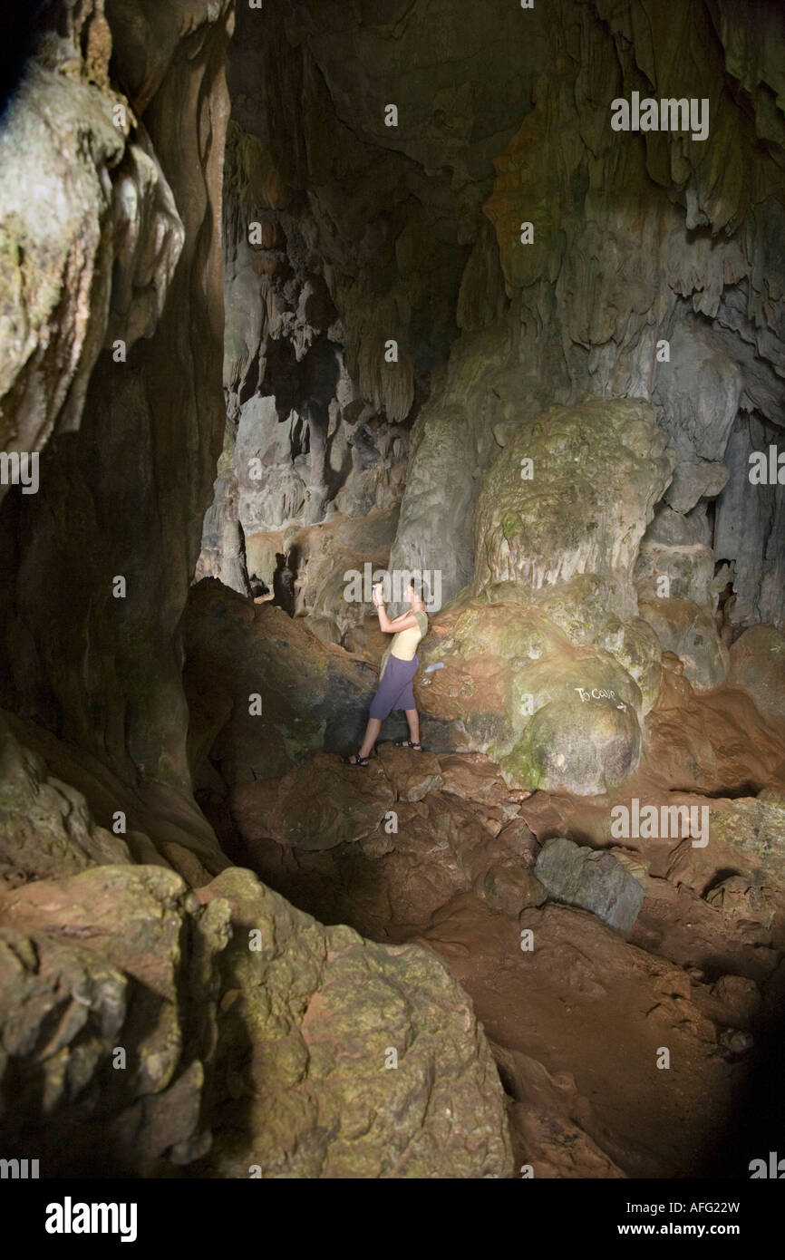 Tourist photographs the large gallery in the Tham Phu Kham (Poukham ...