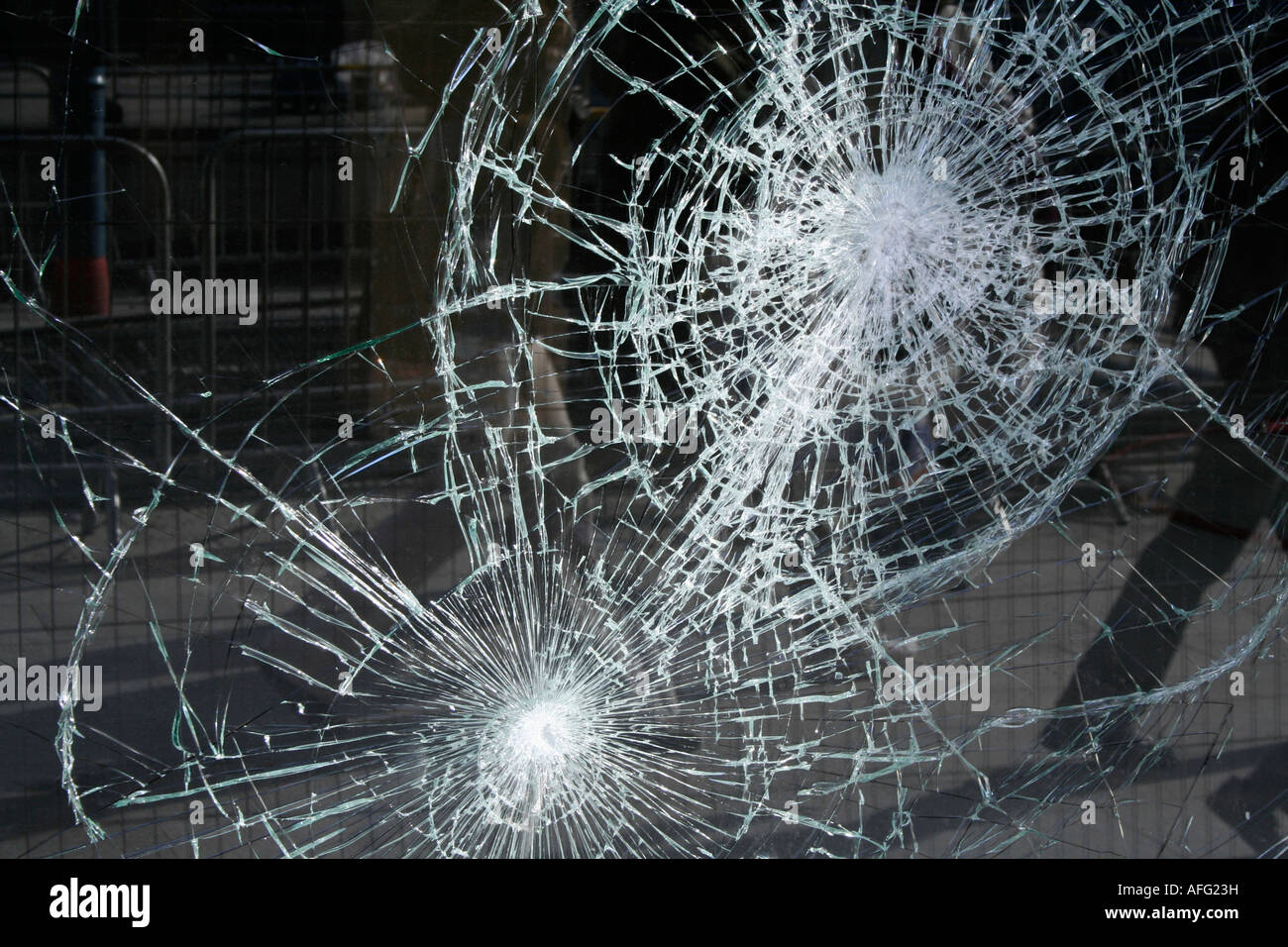 Smashed window with reflection of a pedestrian Stock Photo - Alamy