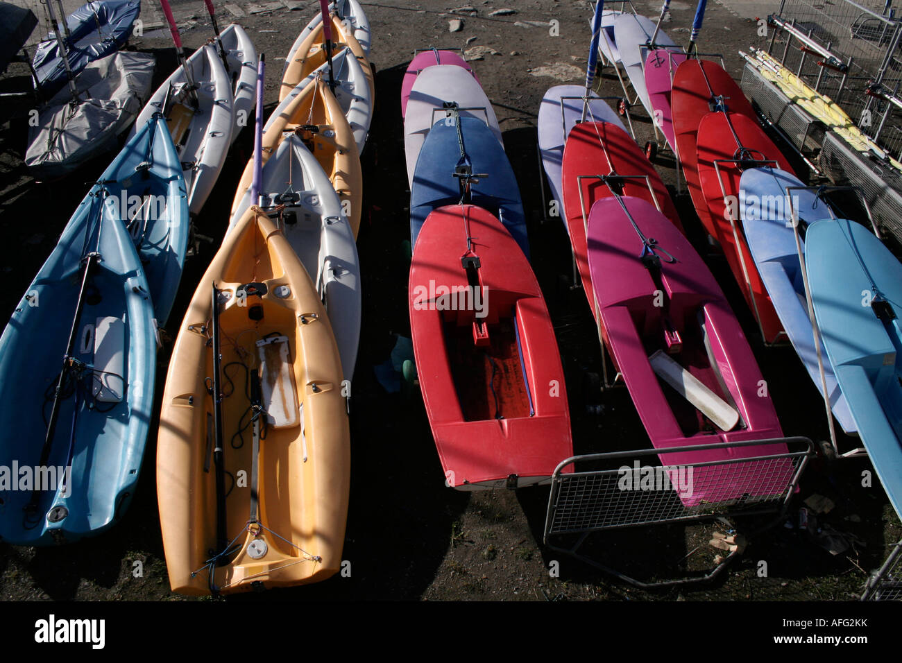 Row of brightly coloured canoes Stock Photo - Alamy