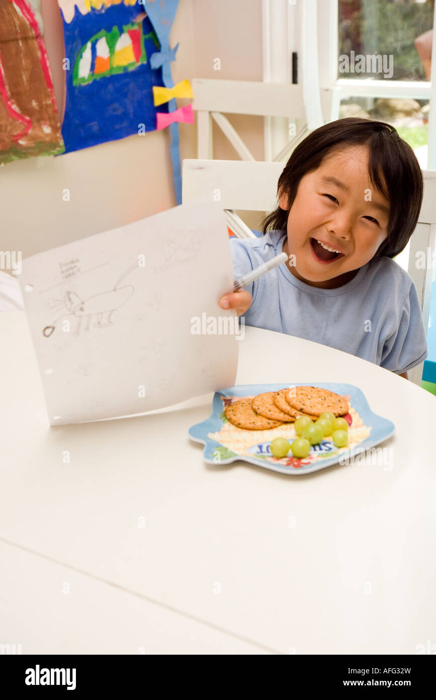 Young Boy Holding up Homework Stock Photo - Alamy