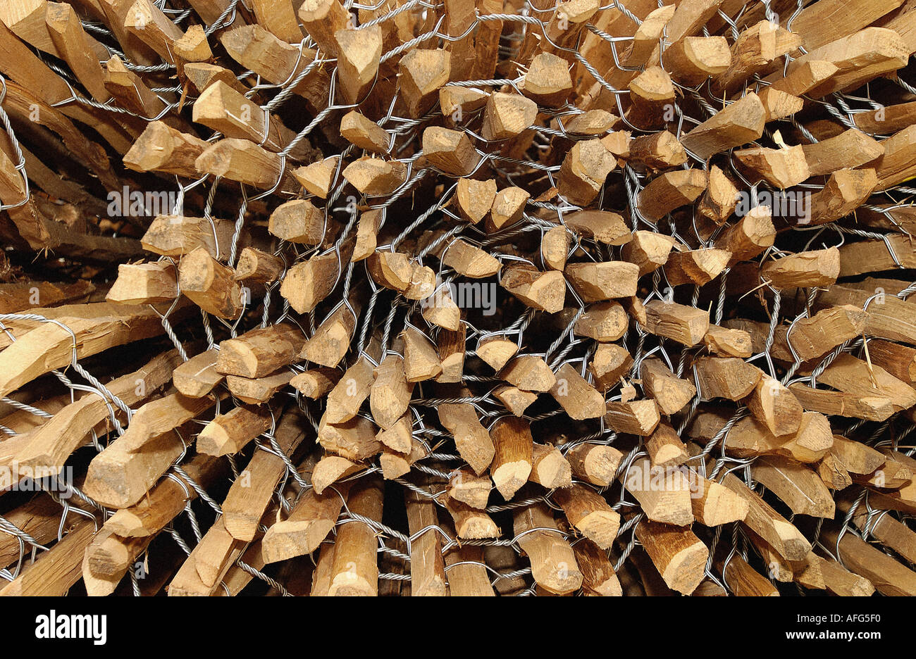 Roll of wooden fencing posts Stock Photo - Alamy