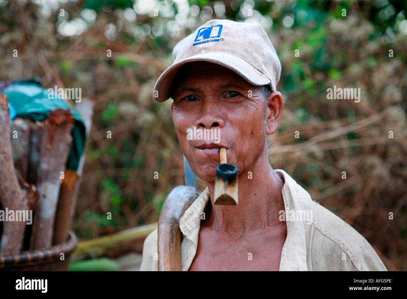 Minority tribesman smoking a pipe, Ratanakiri province, northern ...
