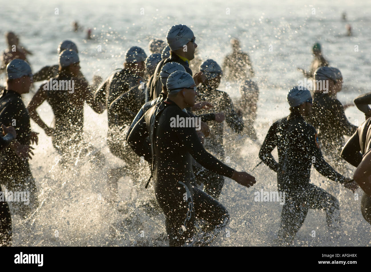 Swimmers run into cold Pacific ocean for swimming section of Santa ...