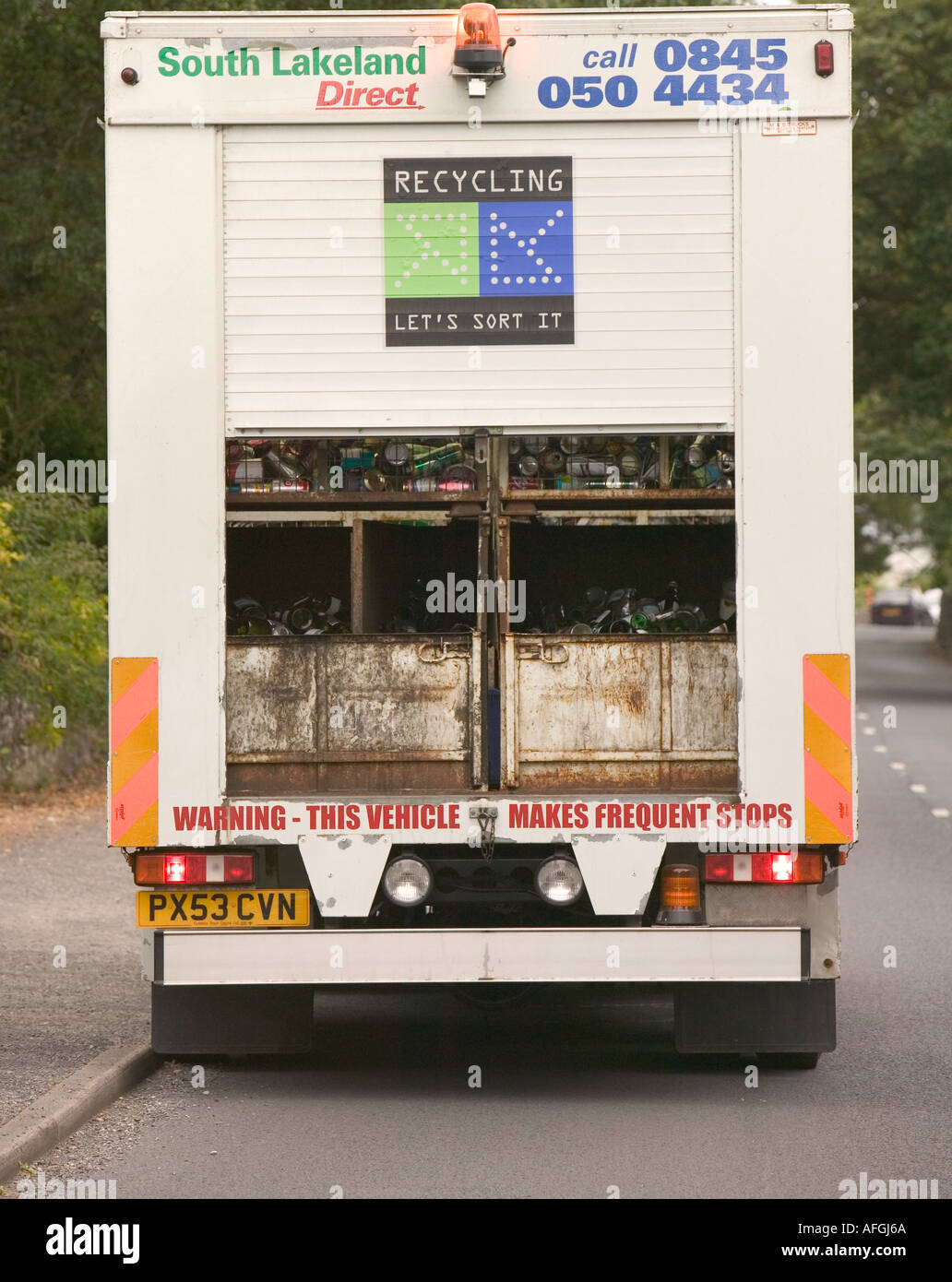 Council workers collecting rubbish to be recycled in a recycling lorry ...