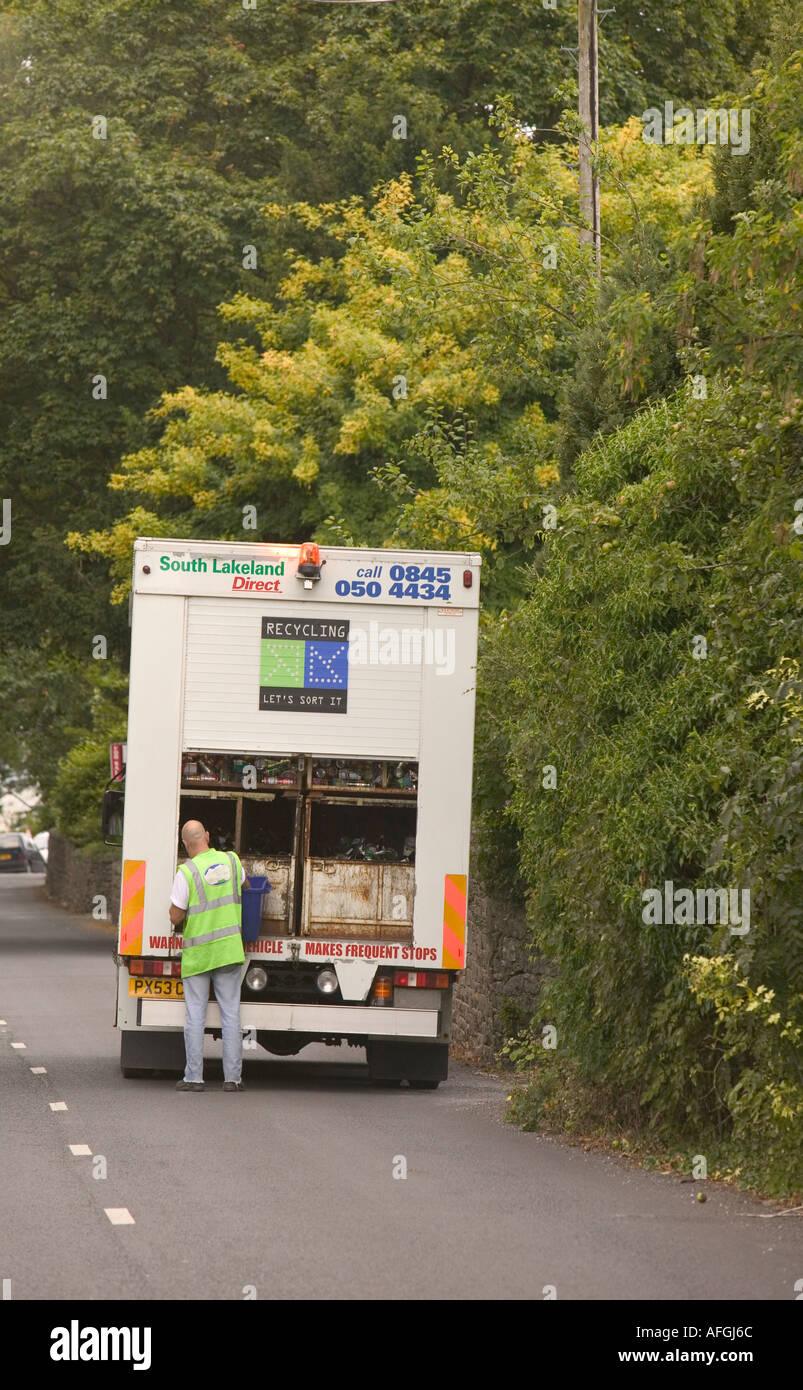 Council workers collecting rubbish to be recycled in a recycling lorry ...