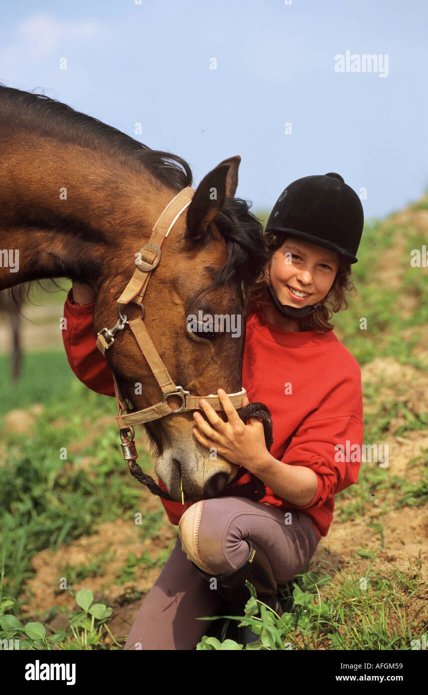 Girl cuddling horse Stock Photo - Alamy
