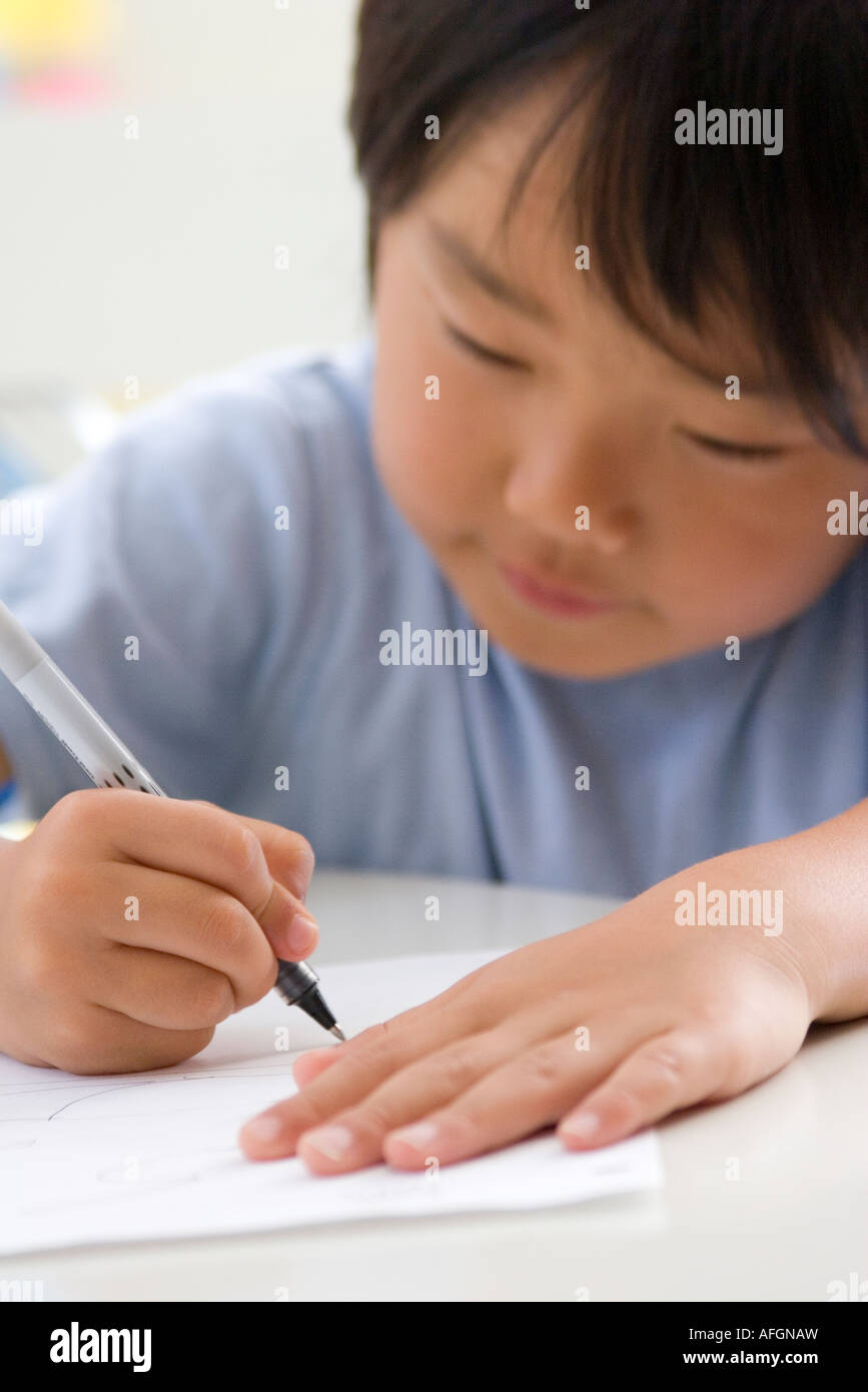 Young Boy Writing Stock Photo - Alamy
