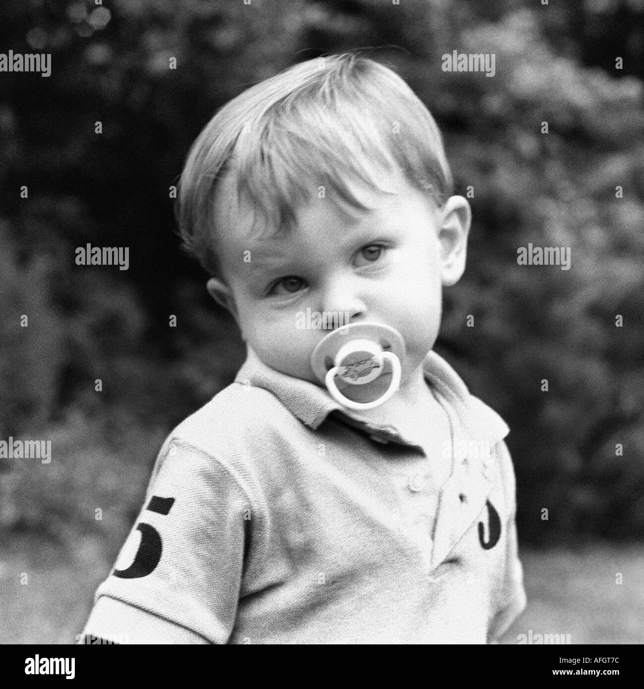 A young boy with a dummy in his mouth Stock Photo - Alamy