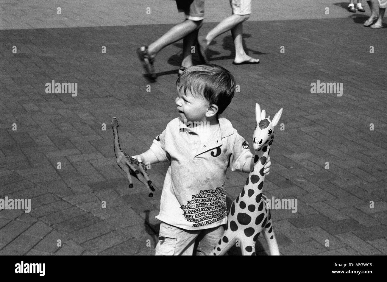 a young boy with toy giraffes Stock Photo - Alamy