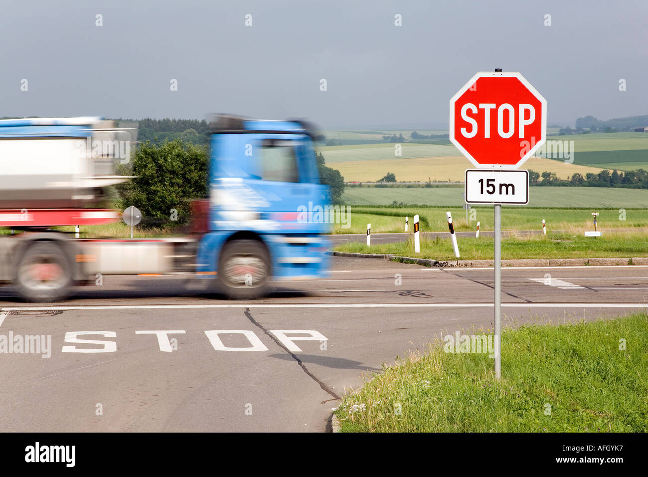 a truck passes a crossing with a stop sign Stock Photo - Alamy
