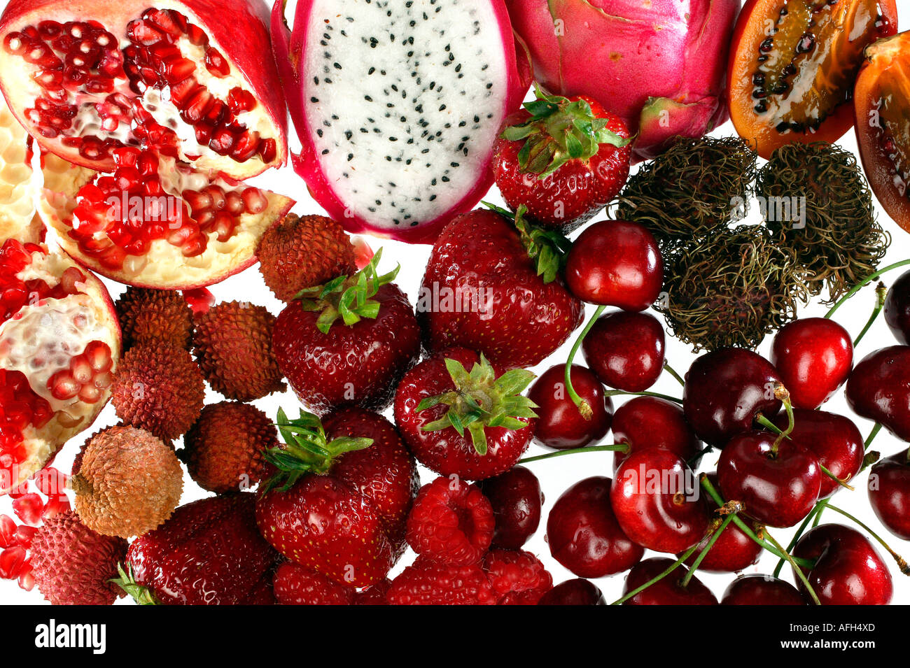 Assorted red fruit on white background Stock Photo - Alamy