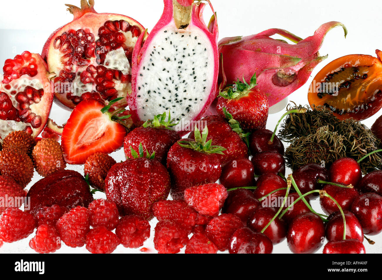 Assorted red fruit on white background Stock Photo - Alamy
