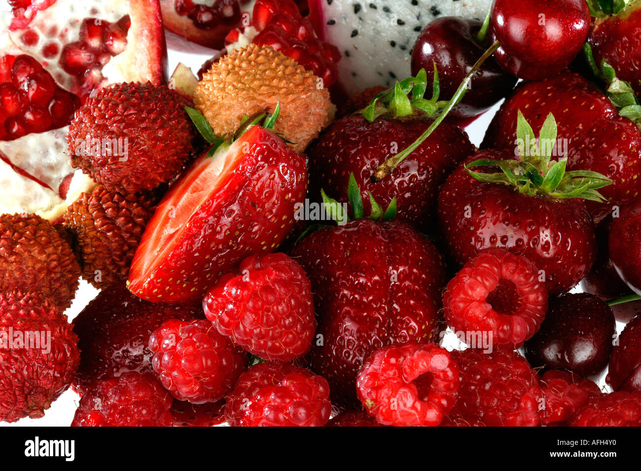 Assorted red fruit on white background Stock Photo - Alamy