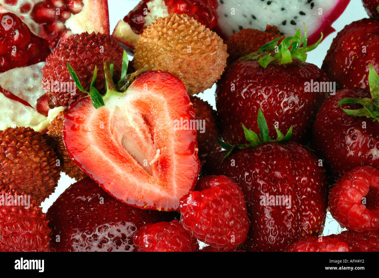 Assorted red fruit on white background Stock Photo - Alamy