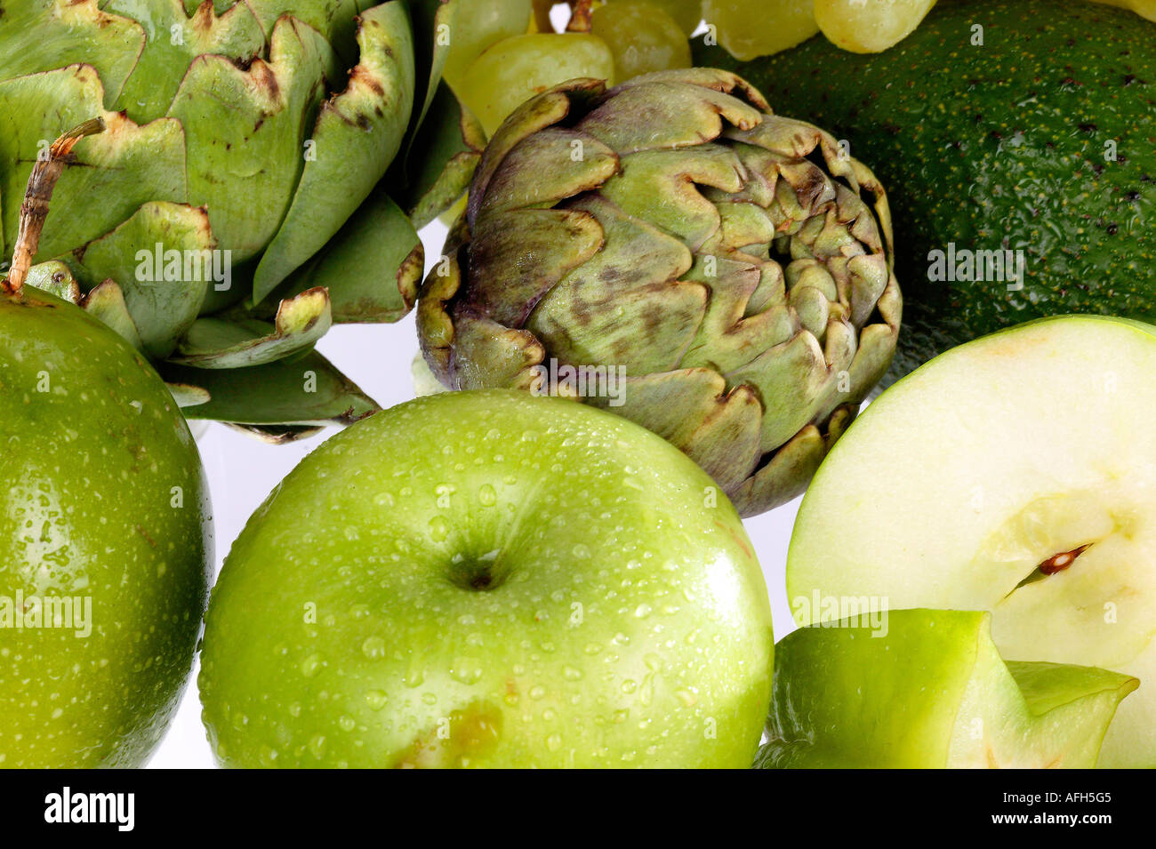 Assorted green fruit on white ground Stock Photo - Alamy