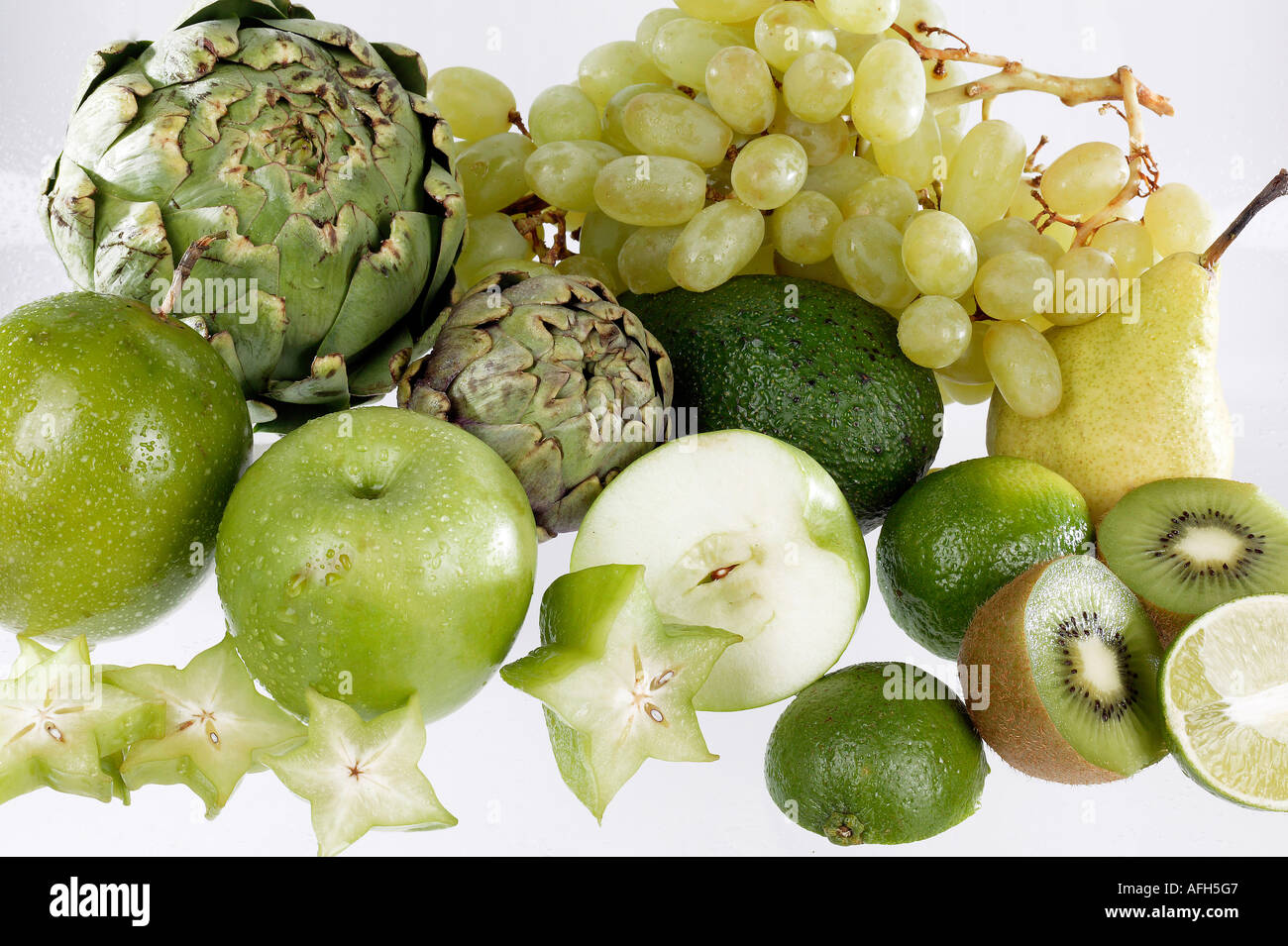 Assorted green fruit on white ground Stock Photo - Alamy