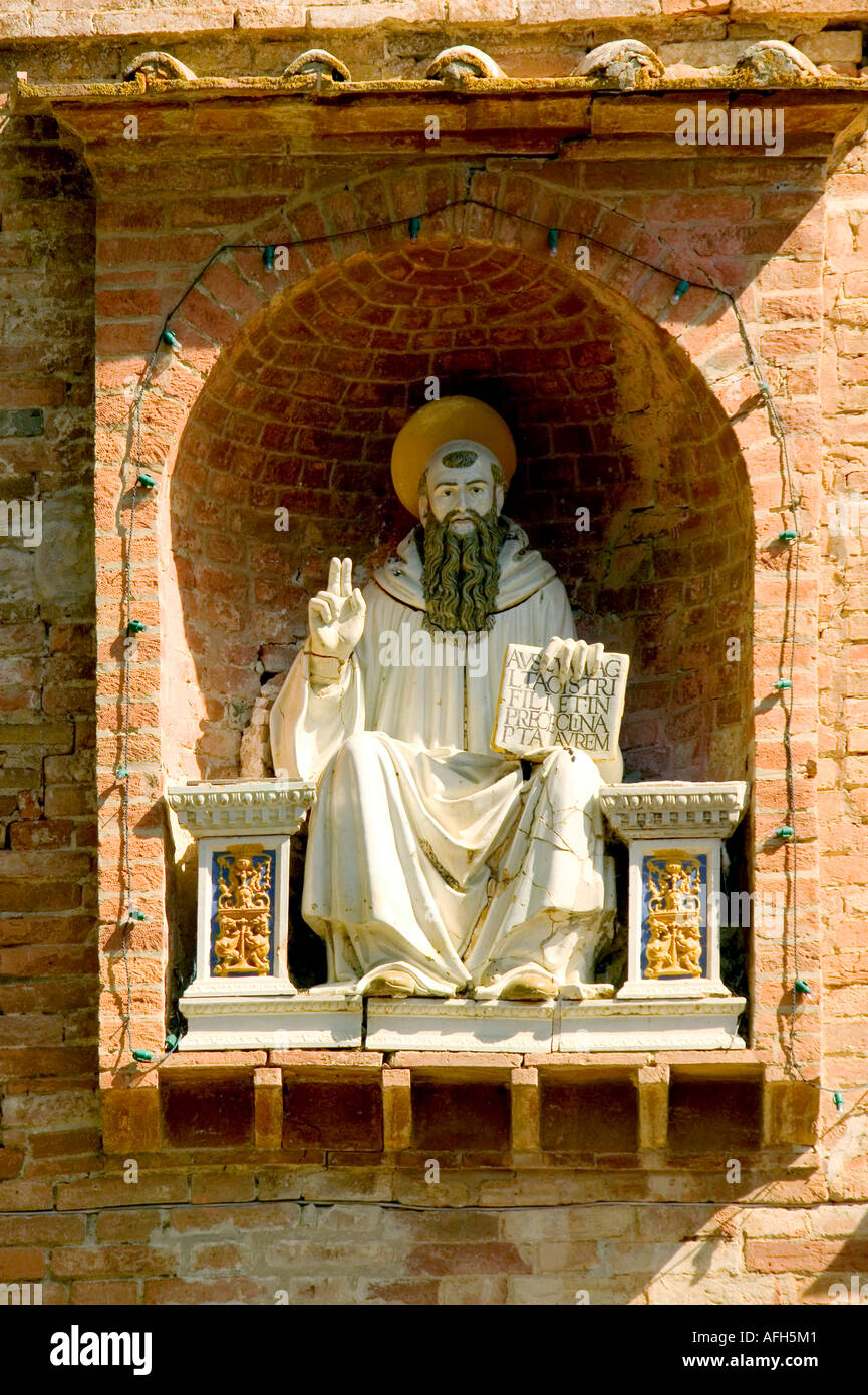 Statue of a saint at the wall of a house in Tuscany, Italy Stock Photo ...