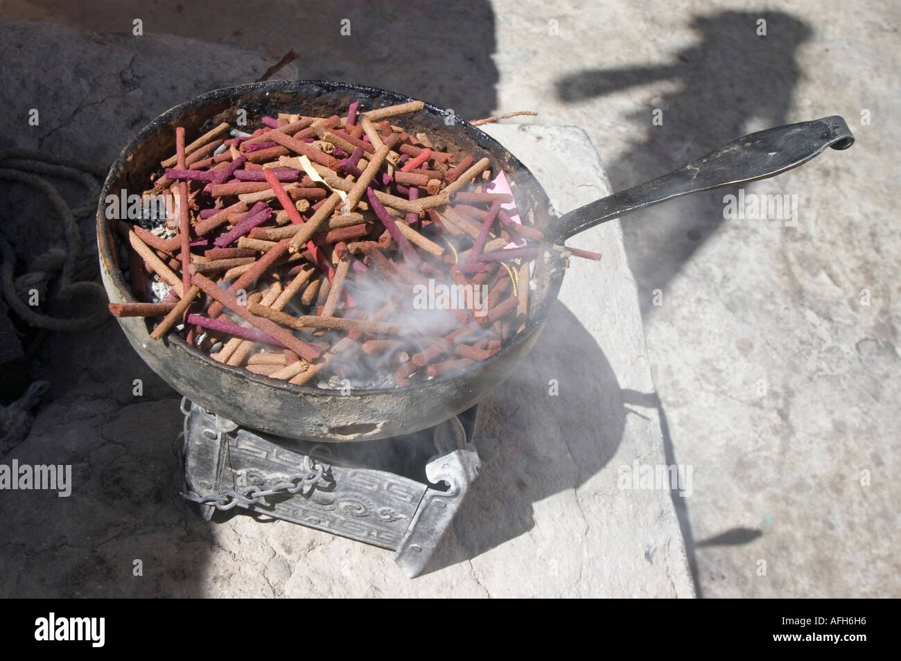 Smoke sticks burning in a bowl as a sacrifice Stock Photo - Alamy