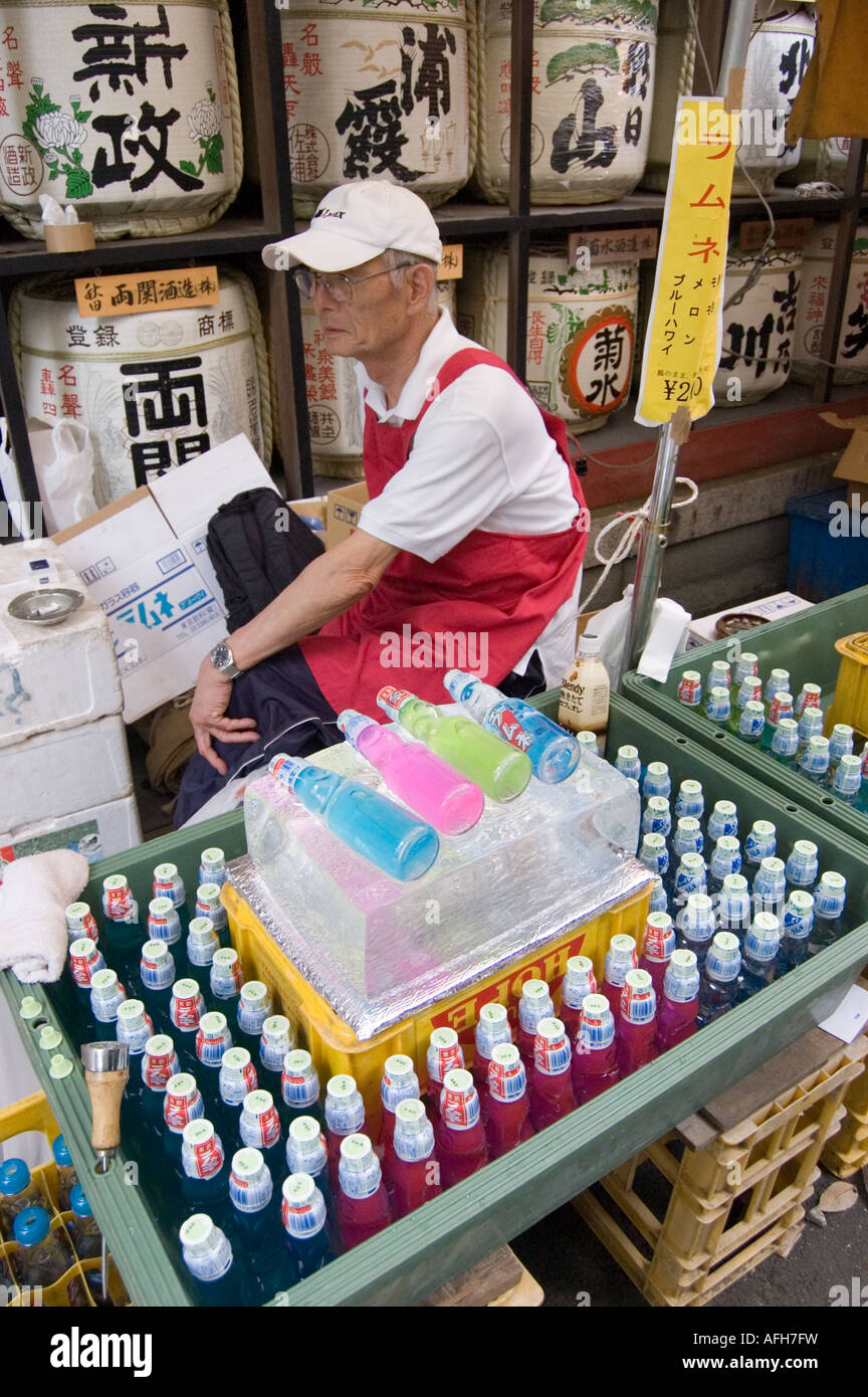 Japanese drink vendor outside a Shinto Shrine Saki barrels in the ...