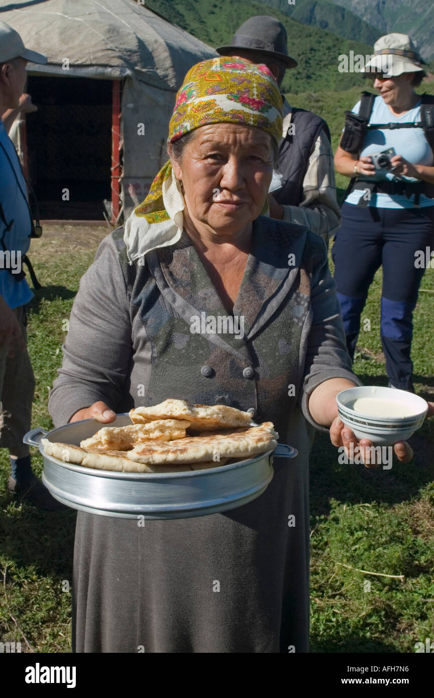 Kirgis woman offering bread and cream as a sign of traditional ...