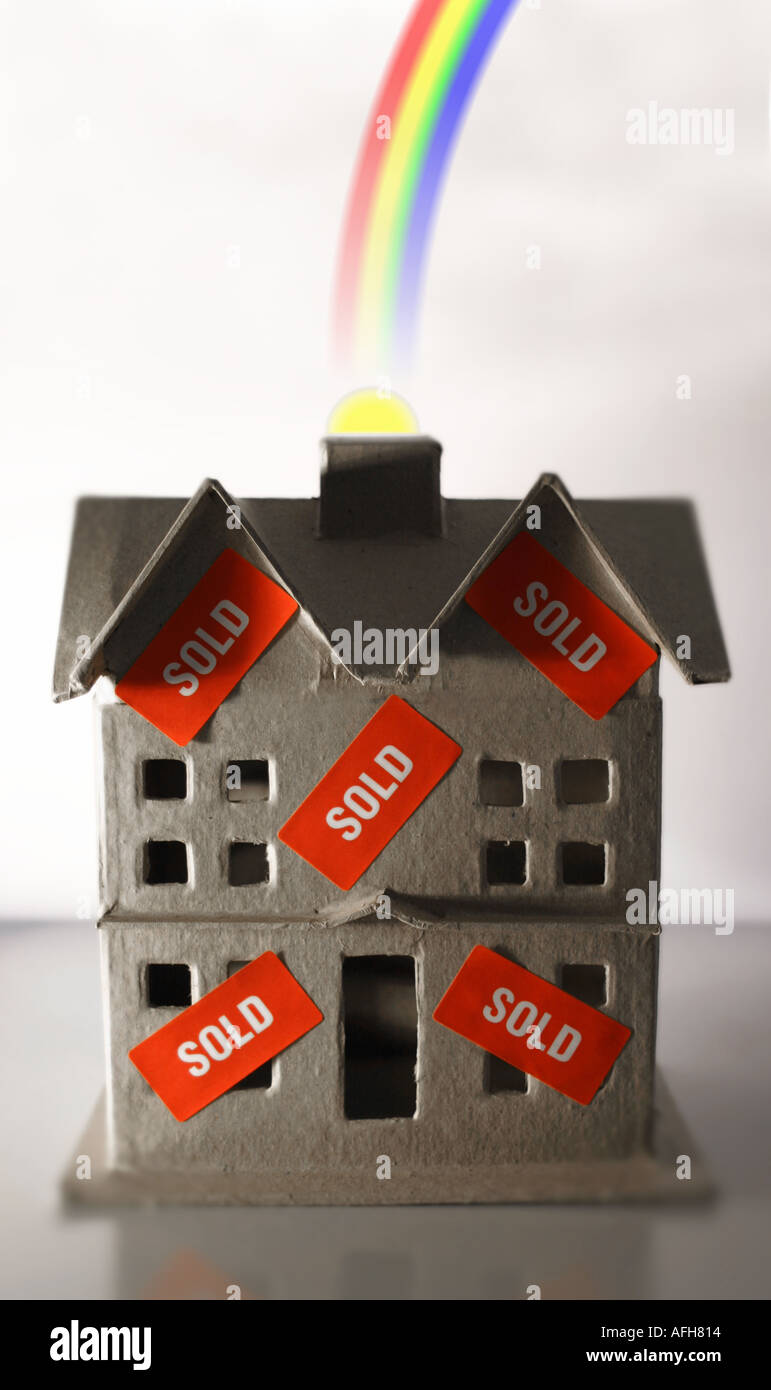 Conceptual image showing a model house with sold signs stuck all over ...